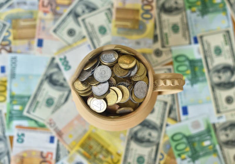 Jug with coins on a table stock photo. Image of banknote - 188716684