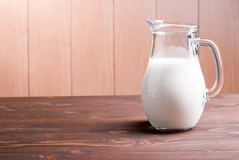 Jug with Milk on a Light Wooden Table Side View Stock Photo - Image of ...