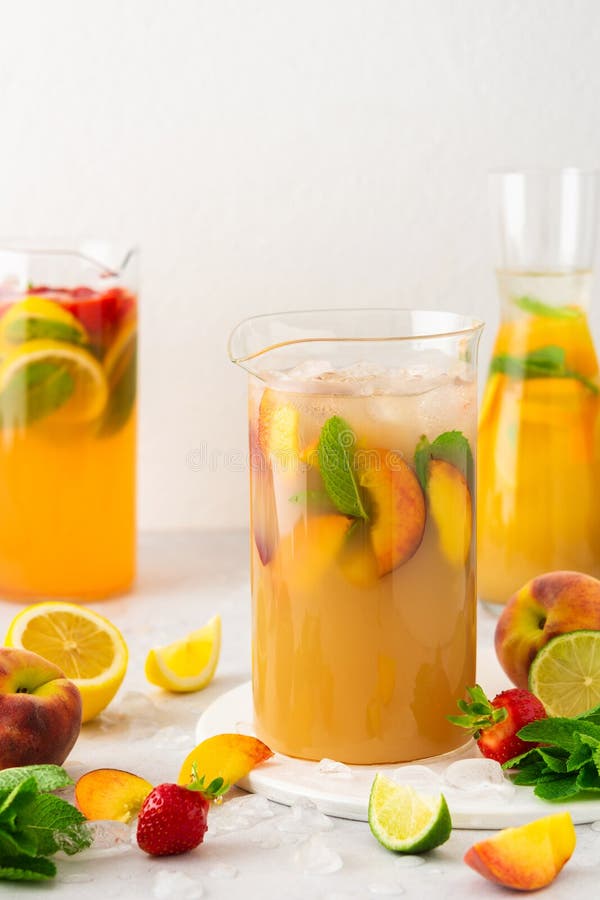 Jugs of Refreshing Fruit Drinks with Fruit Wedges Stock Photo - Image ...