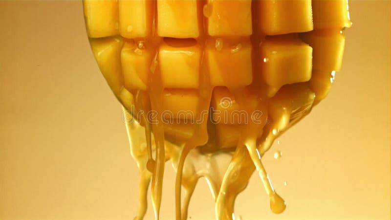 The Juice Flows through the Sliced Mango Fruit. Filmed on a High-speed ...