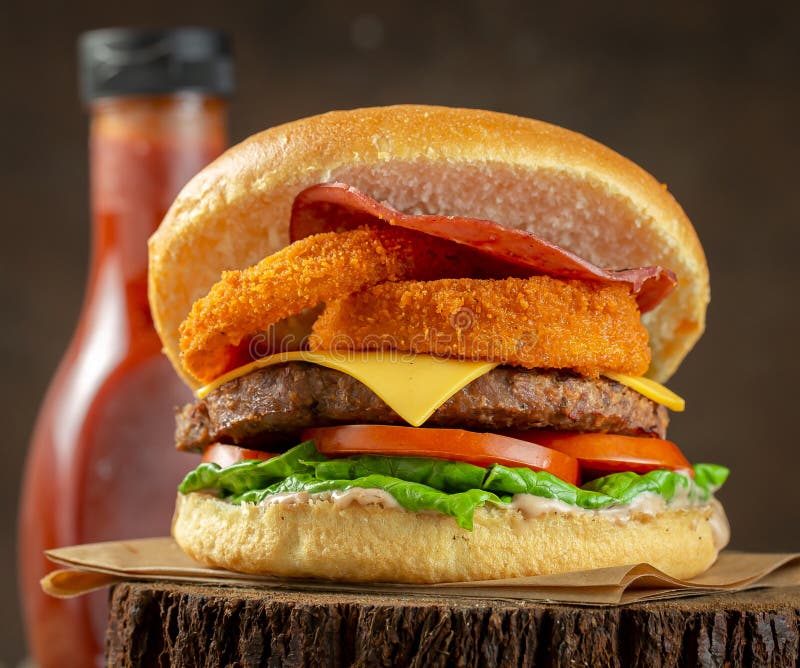Classic Burger with Salami and Crispy Onion Rings. Stock Photo - Image ...