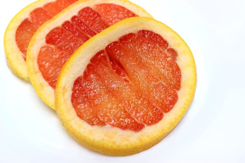 Grapefruit Slices on a White Plate Stock Image - Image of peel, white ...