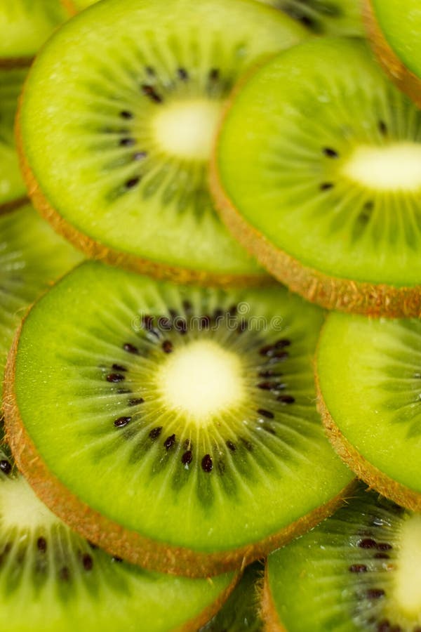 Kiwi Slices and Whole Fruit on Tropical Leaves, Dark Textured ...