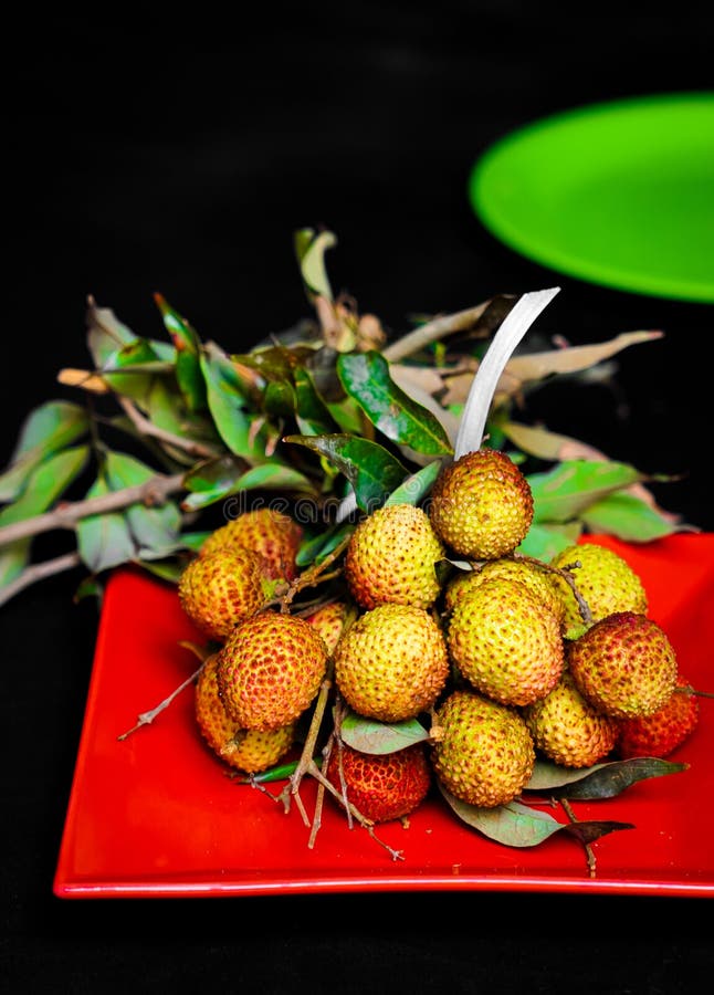 Juicy Lychee Fruit in Red Bowl Over Black Stock Photo - Image of ...