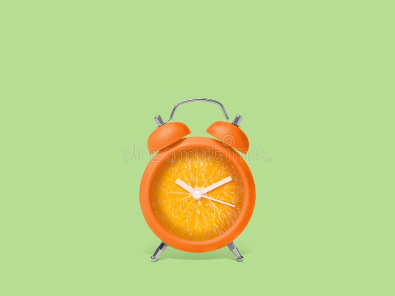 Juicy Orange on Alarm Clock Dial Against Light Green Background ...