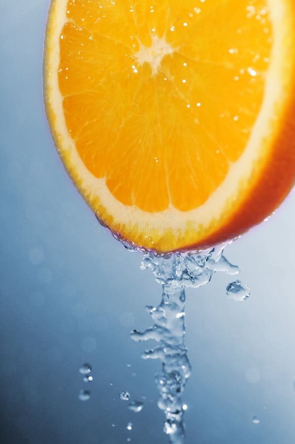 Juicy orange and splashes stock image. Image of flowing - 12094171