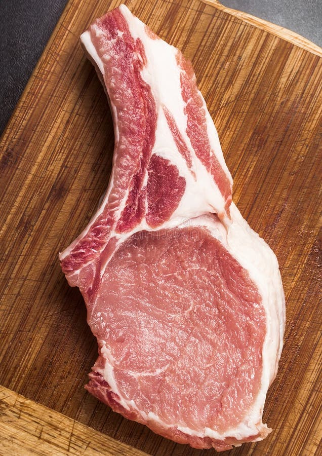 Juicy Piece of Meat on the Bone with Lie on a Wooden Table. Stock Photo ...