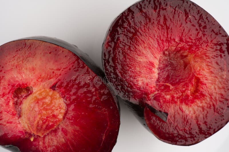 Juicy Plum Cut in Half on a White Background. Closeup Stock Photo ...