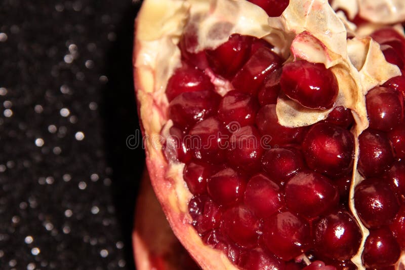 Juicy Pomegranate on a Black Shiny Background. Bright Pomegranate ...