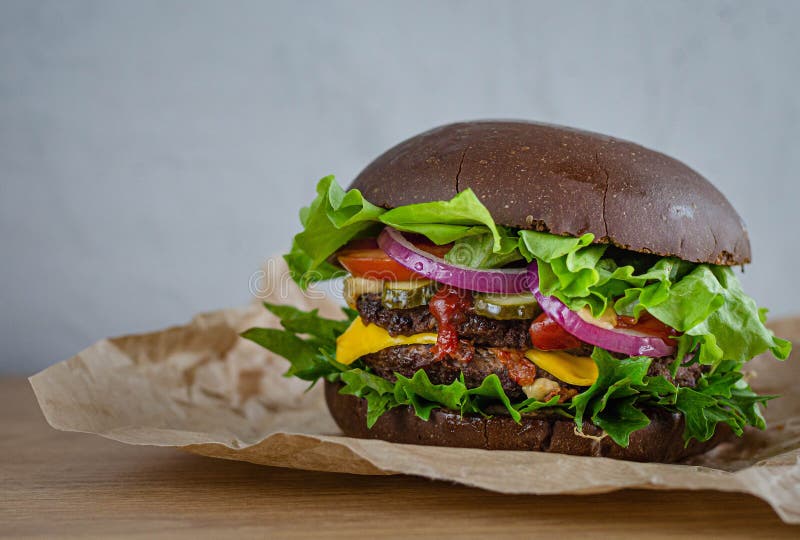 Juicy Powerful Burger with Beef and Vegetables on a Rye Bun Stock Image ...