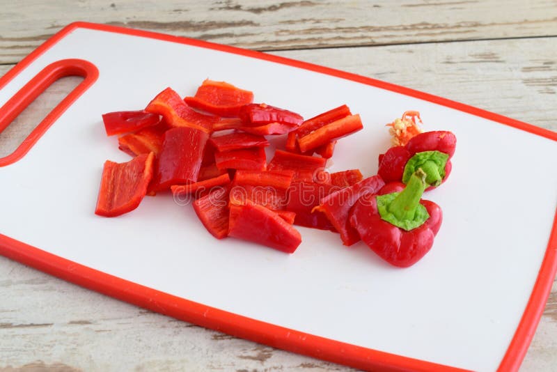 Juicy Red Bell Pepper Cut Up on White Cutting Board. Step by Step ...