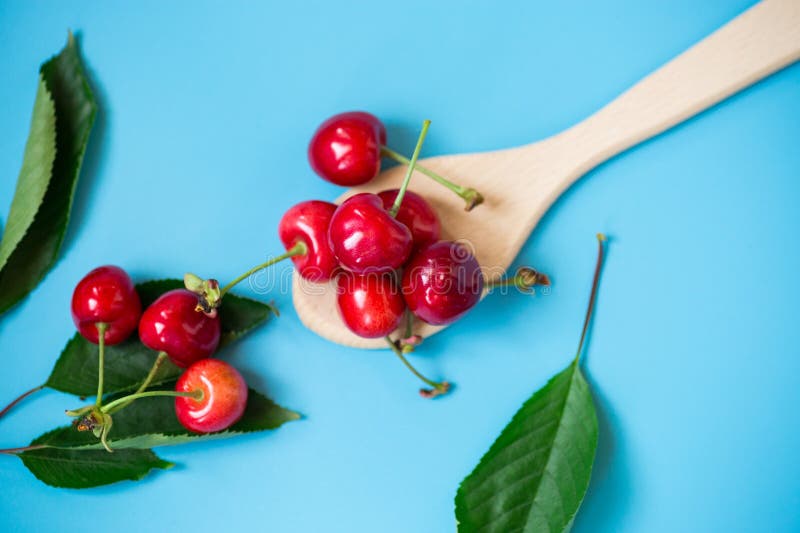 Juicy Ripe Cherries Close-up on a Blue Background Stock Image - Image ...