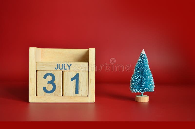 July 31, Calendar Design with Christmas Tree on a Red Table Background ...