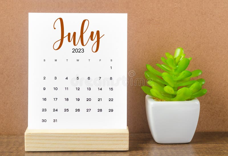 The July 2023 Monthly Calendar for 2023 Year on Wooden Table Stock ...