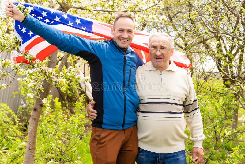 July 4th: American Family Behind US Flag. Stock Image - Image of ...