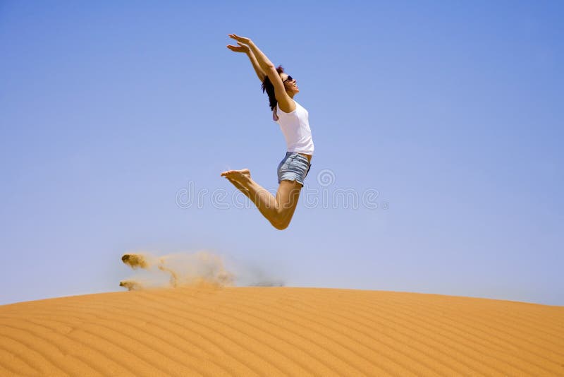 Girl Jumping on the Yellow Sand Dune Stock Photo - Image of back, blue ...