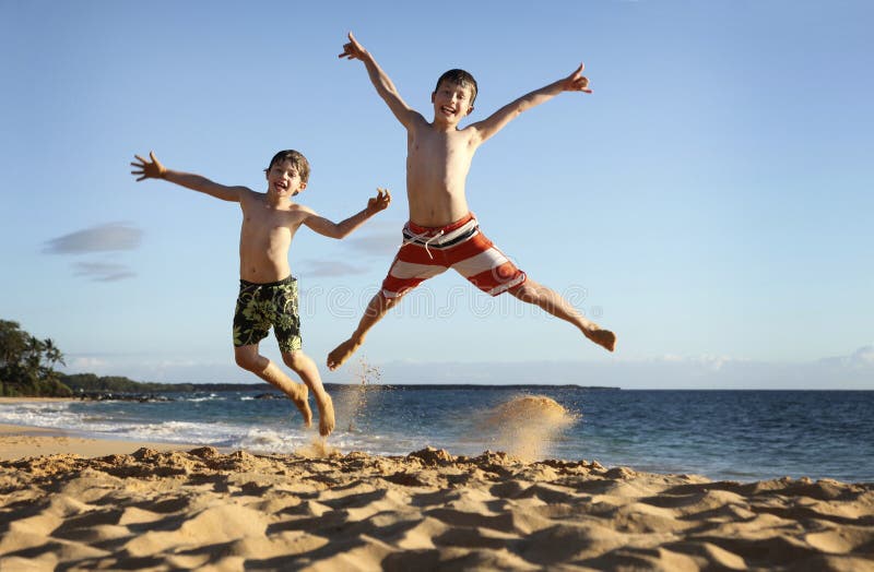 Jump at the beach stock photo. Image of youth, beach - 23539958