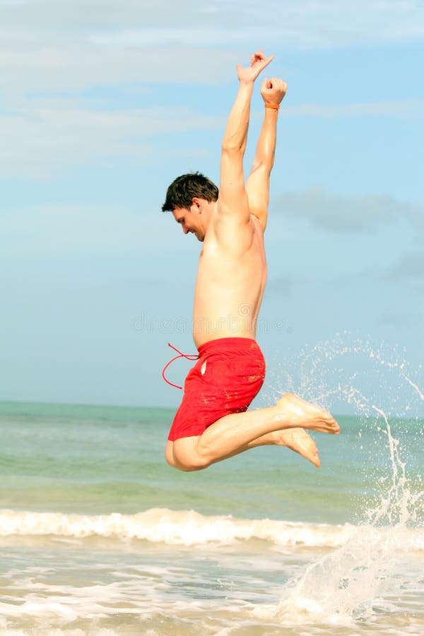 Jump on the beach stock image. Image of handsome, jump - 4629491