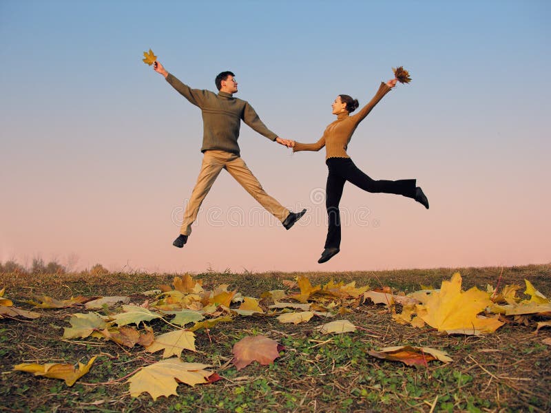 Jump couple autumn leaves stock photo. Image of happy, grass - 295144