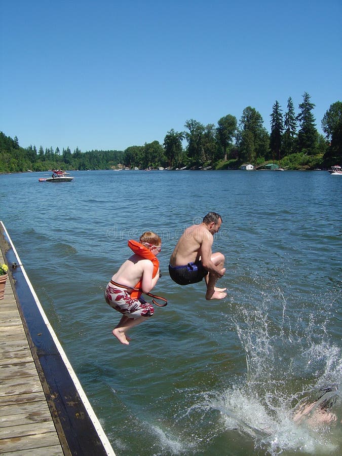 Boy jumping into lake stock photo. Image of lake, flip - 2908418
