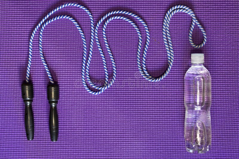 Jump Rope and Bottle of Water on Violet Mat Stock Photo - Image of ...