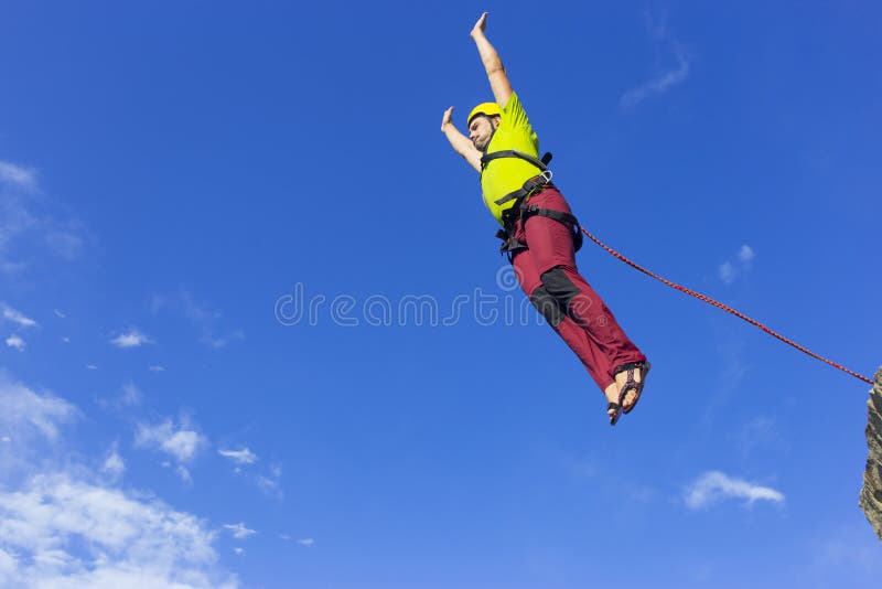 Jump Rope from a High Rock in the Mountains. Stock Photo - Image of ...
