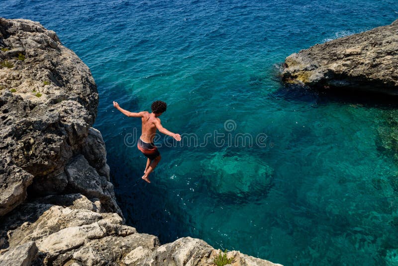 Jumpig in the sea stock photo. Image of italy, landscape - 194634516