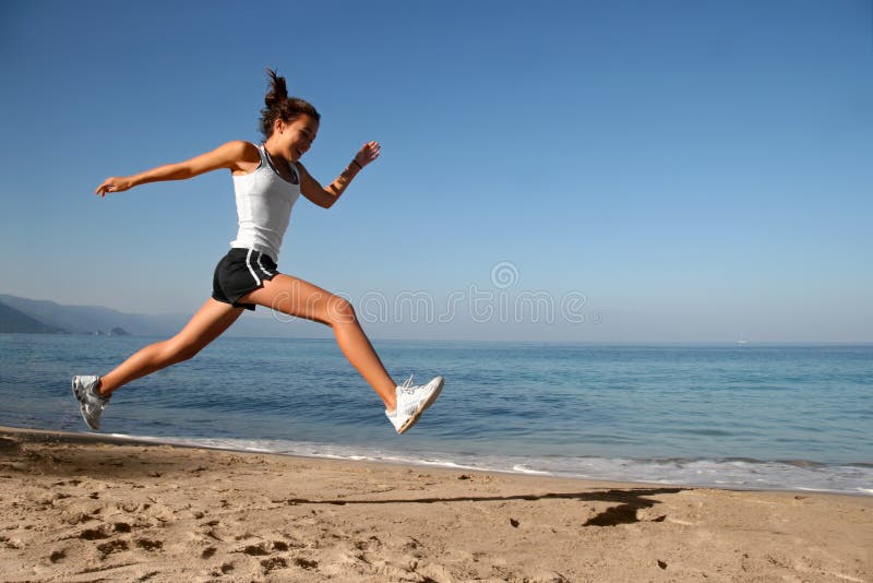 Jumping on the beach stock image. Image of ocean, athletic - 1658831