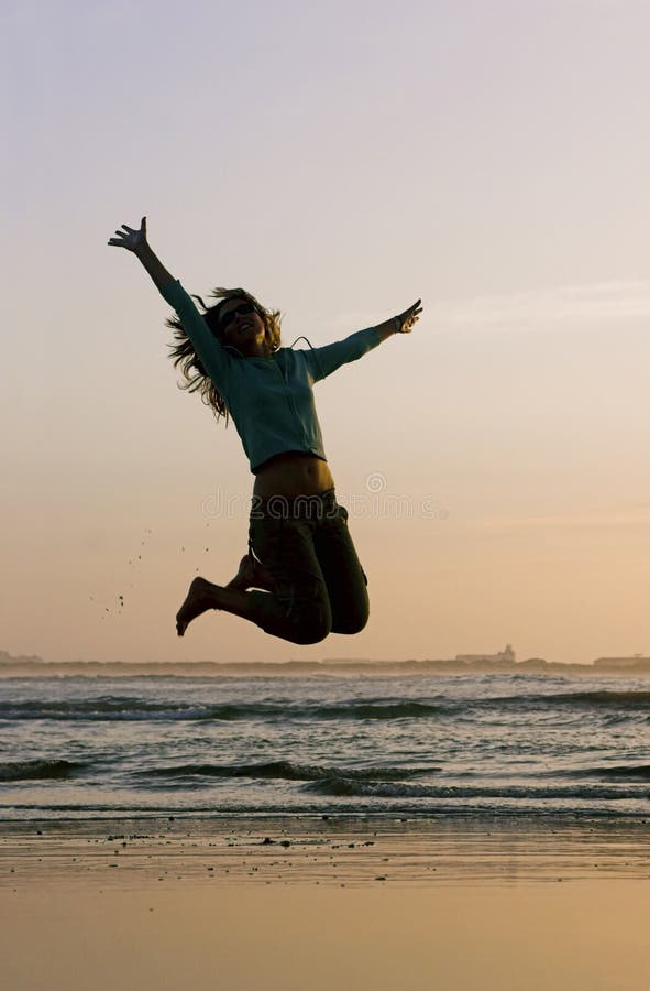 Woman jumping on a beach stock image. Image of portrait - 5863193