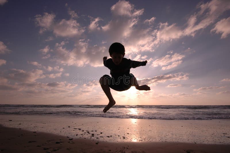 Jumping on the beach stock image. Image of sunset, nature - 2206145