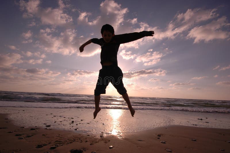 Beach Silhouettes Jump for Joy Stock Image - Image of seashore, ocean ...