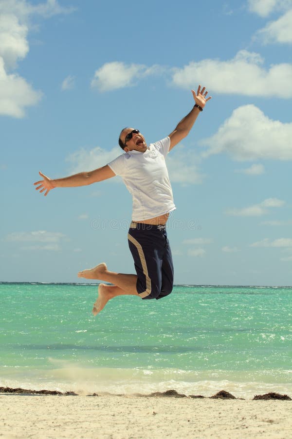 Jumping on the beach stock image. Image of paradise, caribbean - 23565521