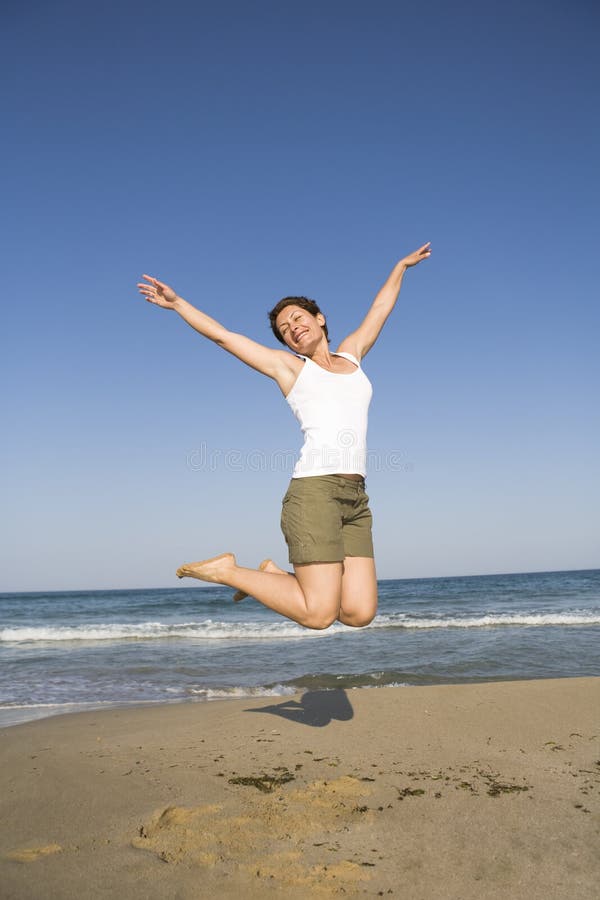 Jumping on the beach stock image. Image of high, girl - 5122479