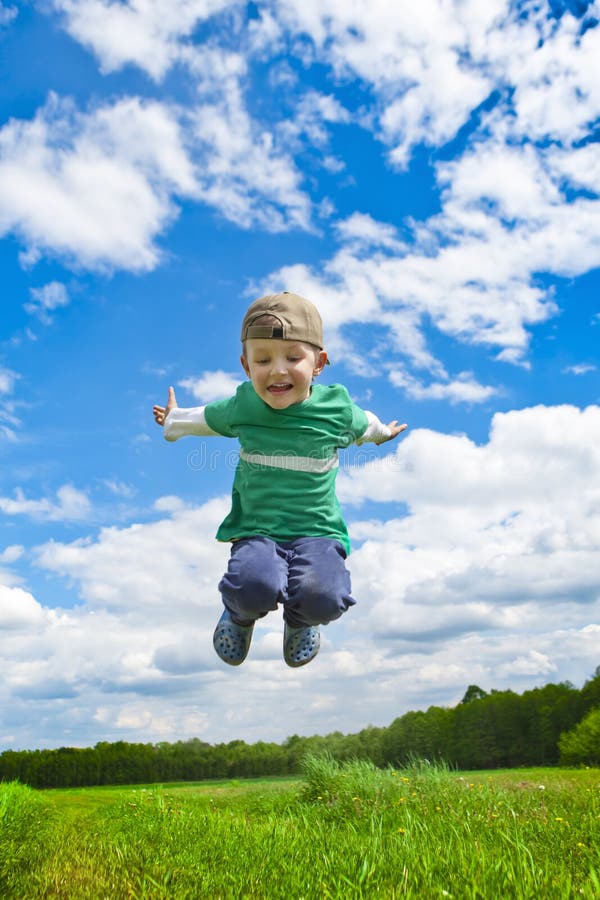 Jumping boy outside. stock photo. Image of people, baby - 55614892
