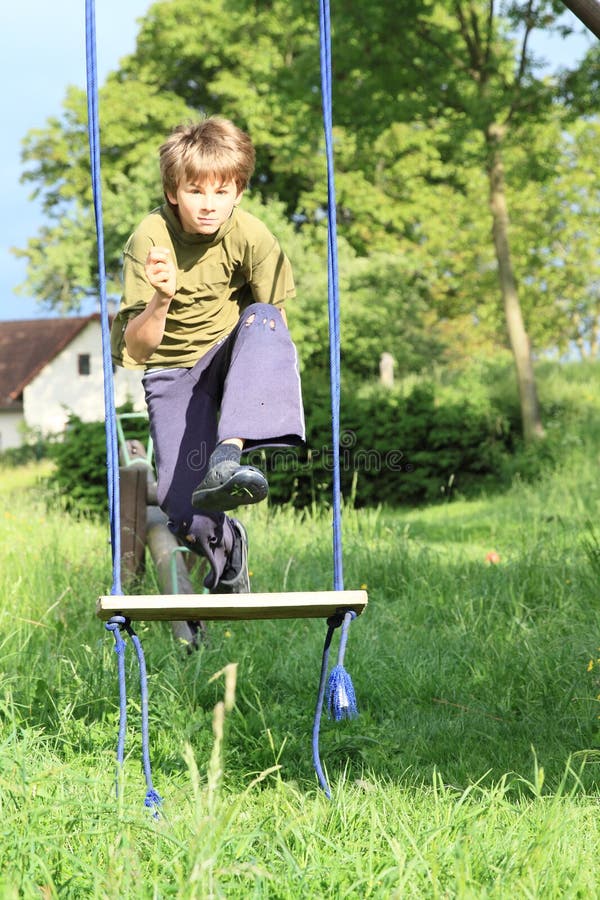 Kid jumping from swing stock photo. Image of springtime - 13375434