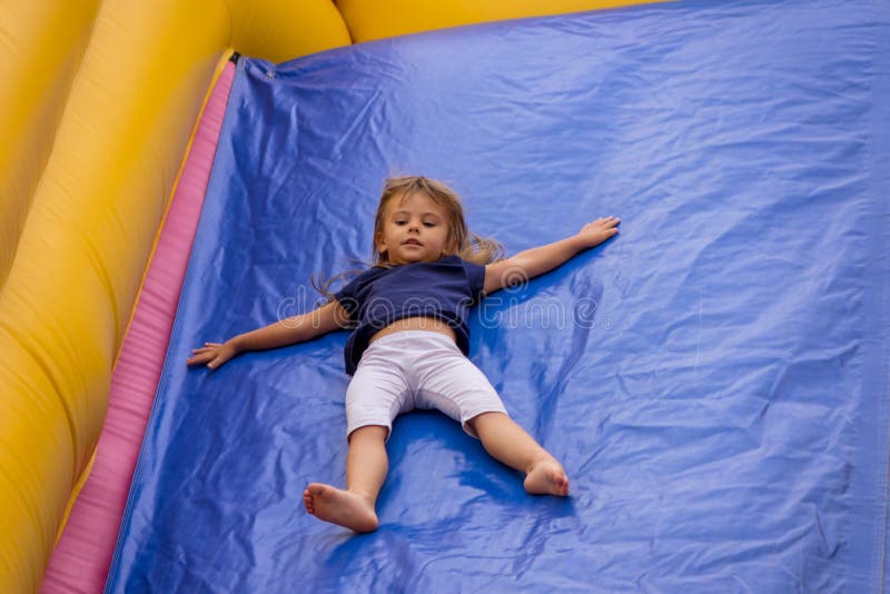 Jumping and Descending on a Rubber Slide Stock Image - Image of bouncy ...