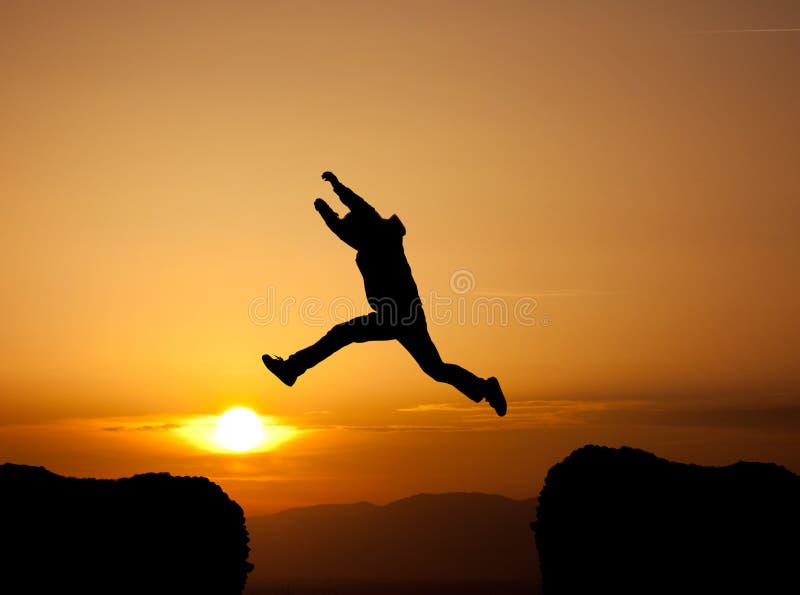 Silhouette of the Jumping Man from a Rock Stock Photo - Image of ...
