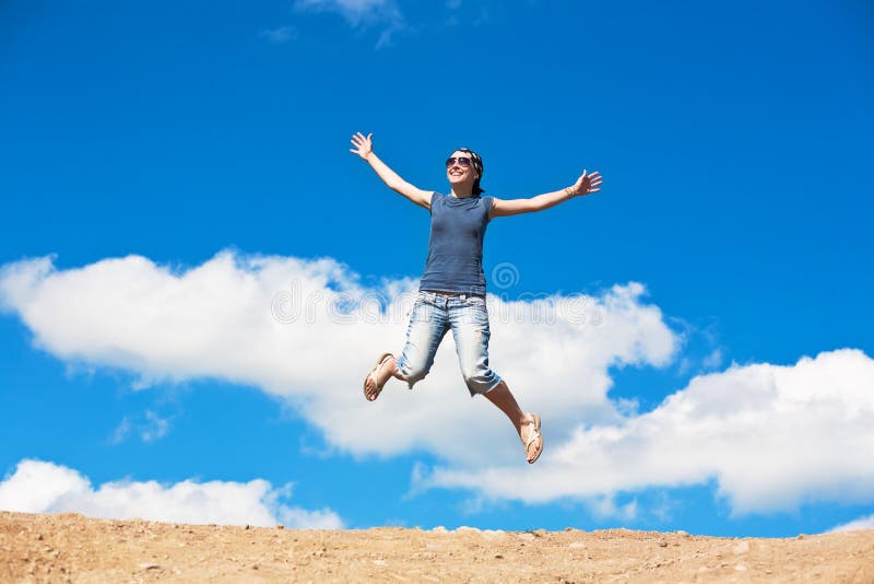 Jumping Girl with Hands Up Against Stock Image - Image of delight ...