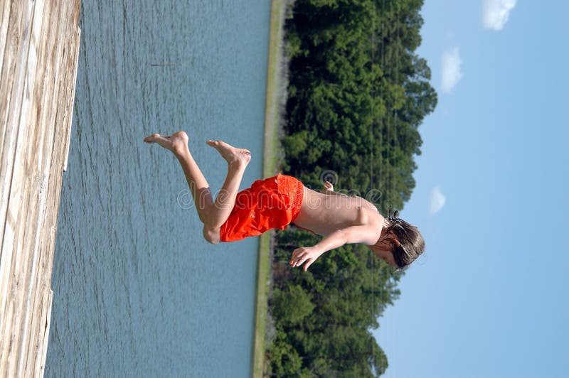 Boy jumping into lake stock image. Image of nature, child - 5932469