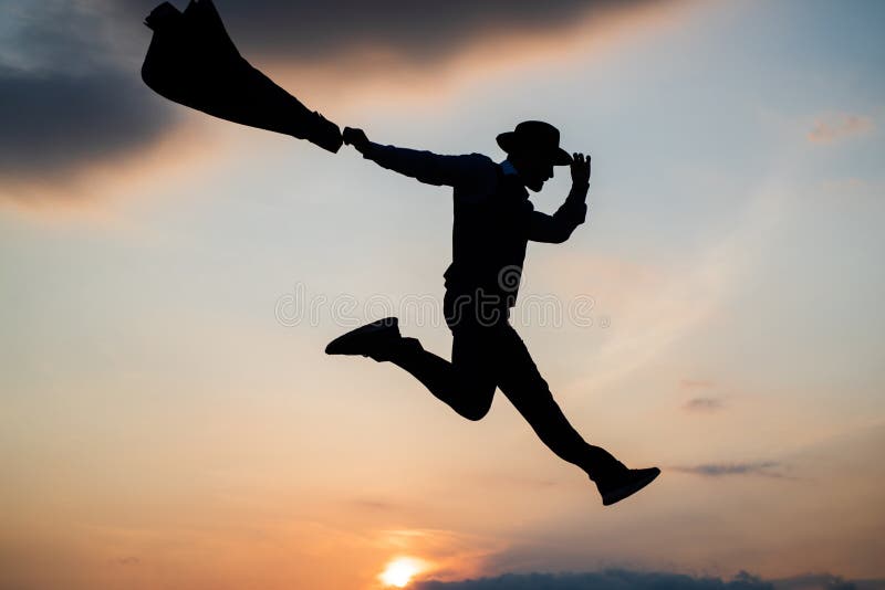 Jumping Man Silhouette with Hat and Jacket Dance Against Sunset Sky ...