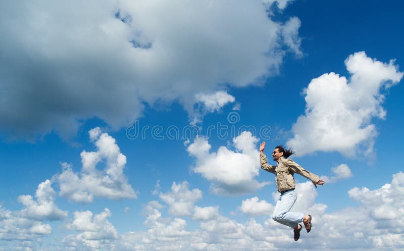 Crazy Man in Goggles is Flying in in the Cloudy Sky. Jumper Concept ...