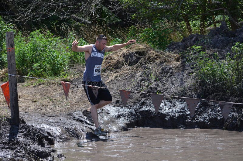 Jumping into mud editorial stock photo. Image of sport - 26137338