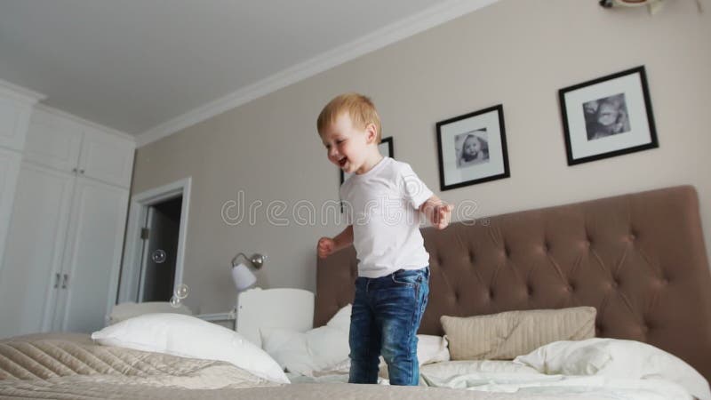 Jumping Off of Happiness on the Bed Looking at Flying Soap Bubbles ...