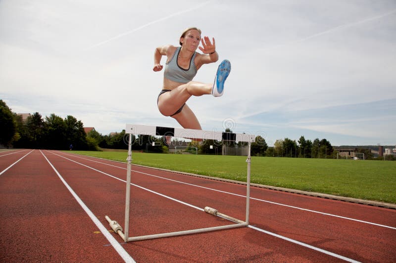 Athlete Jumping Over Hurdles Stock Photo - Image of field, fast: 17419204