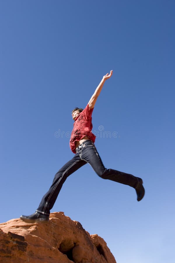 Jumping on red rocks stock image. Image of rocks, fitness - 3577803
