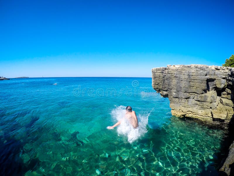 Jumping in to the sea stock image. Image of holiday, holidays - 76517121