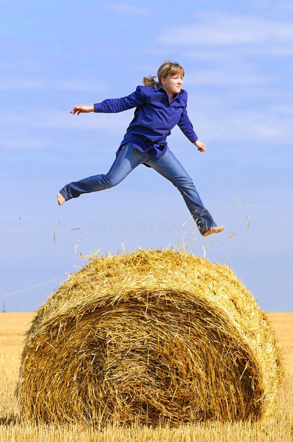 Jumping up on straw roll stock photo. Image of empty - 10571082