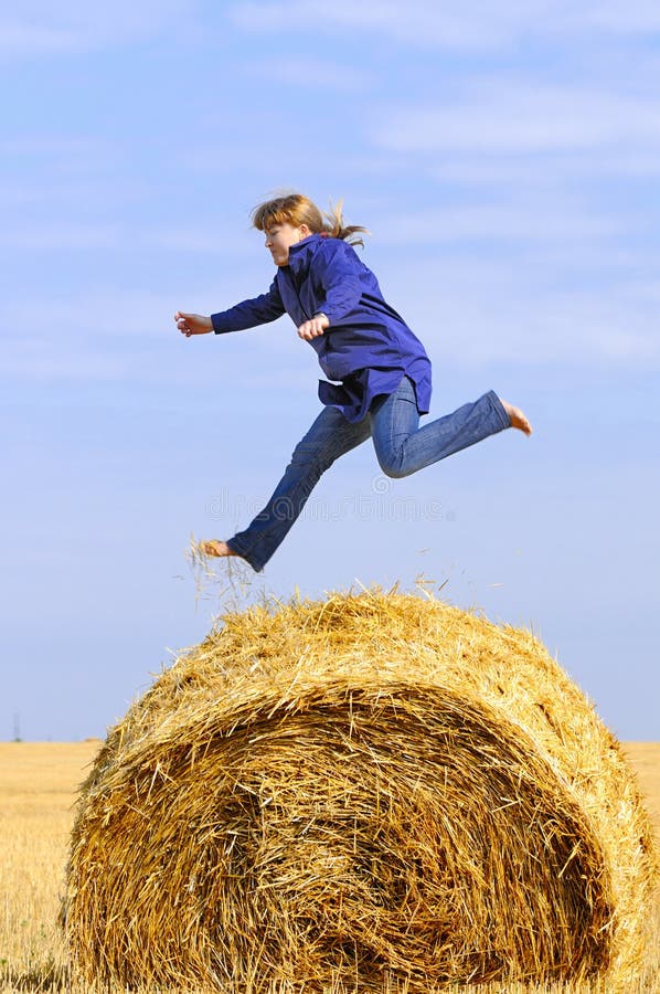 Jumping up on straw roll stock photo. Image of agricultural - 10721380