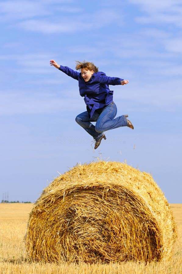 Jumping up on straw roll stock image. Image of corn, happy - 10942223