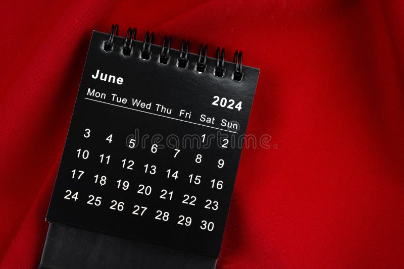 June 2024 Black Spiral Desktop Calendar on Red Textile Stock Photo ...